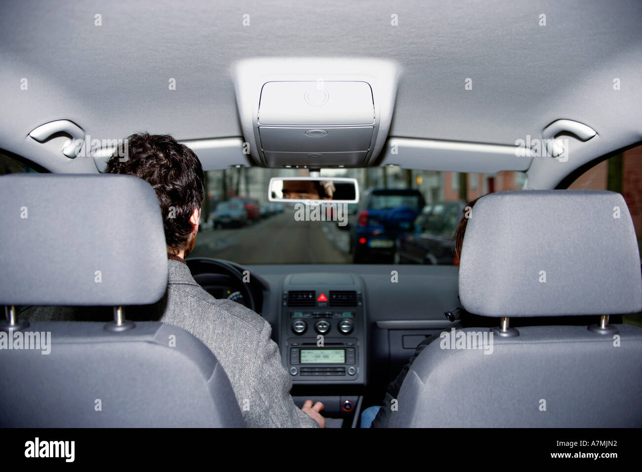 Rear view of man driving car Stock Photo - Alamy