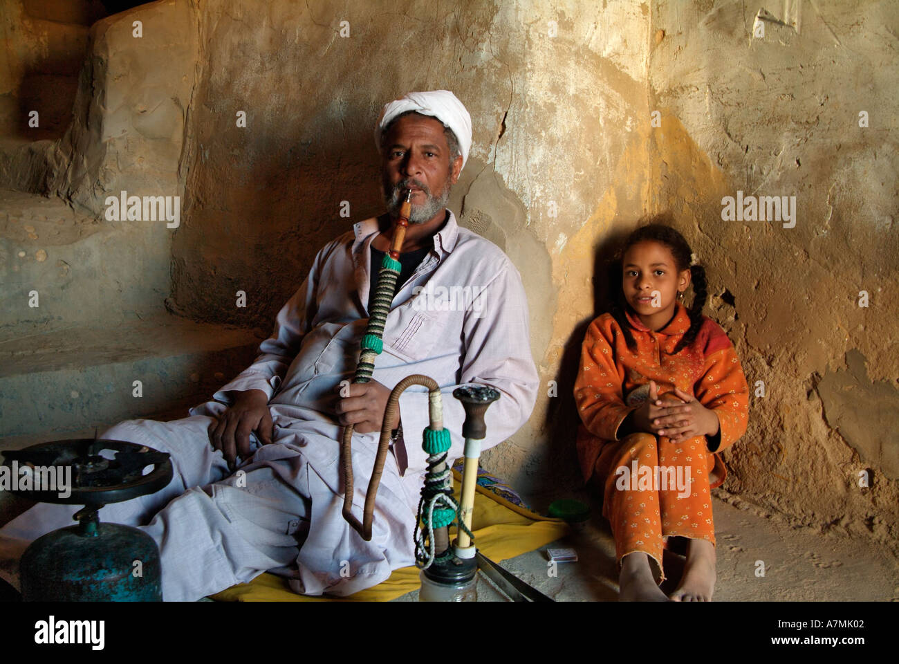Egyptian man smoking a sheesha pipe and his daughter, Siwa, Egypt Stock ...