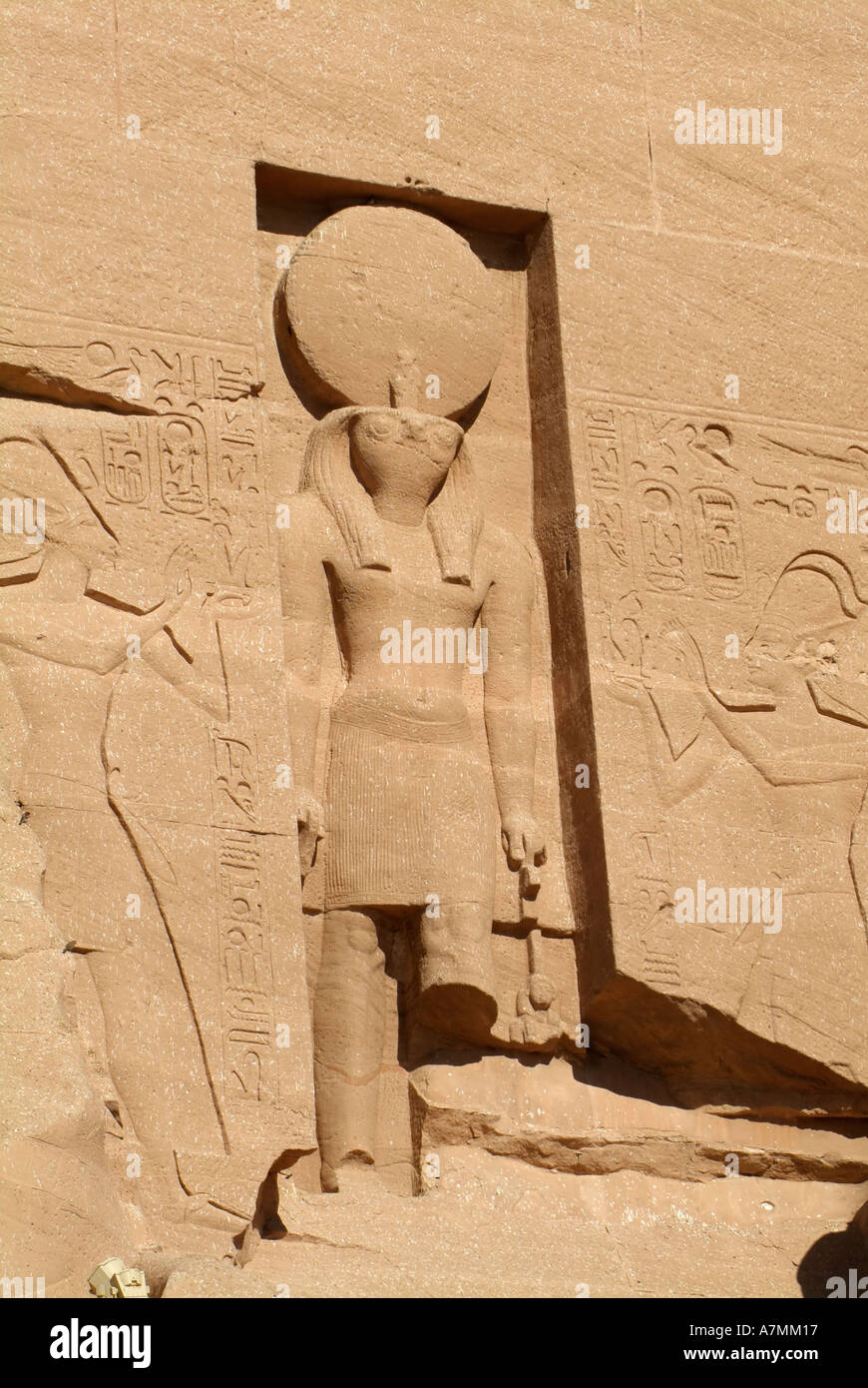 Falcon headed sun god Ra, between the heads of the colossal statues of ...