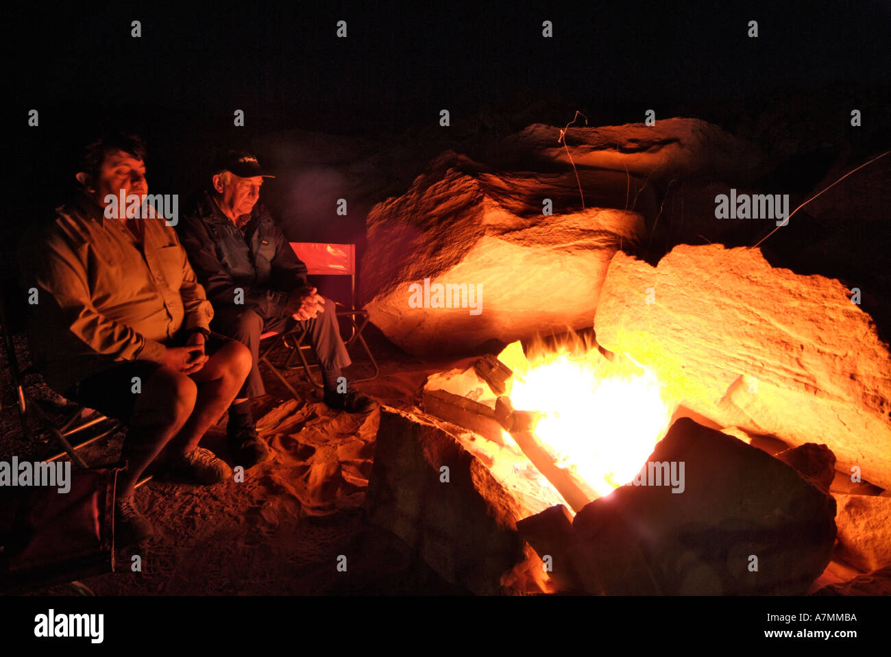 Group sitting around the campfire, bush camp in the Sahara Desert ...