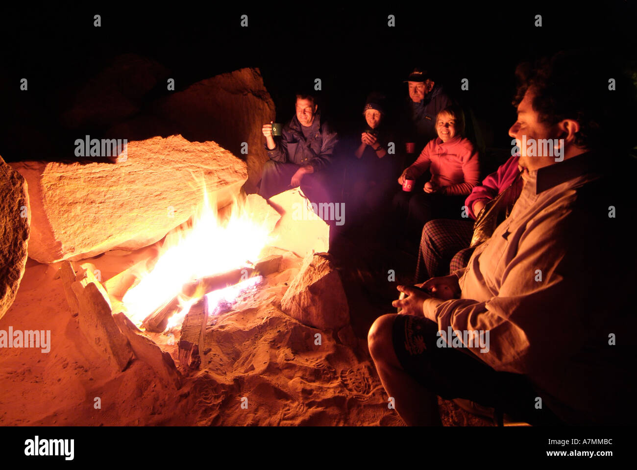 Group sitting around the campfire, bush camp in the Sahara Desert ...