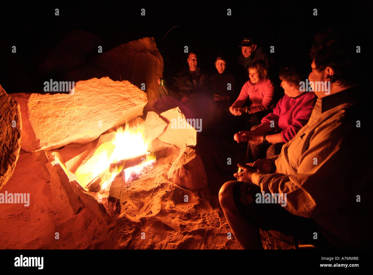 People sitting around campfire night hi-res stock photography and ...