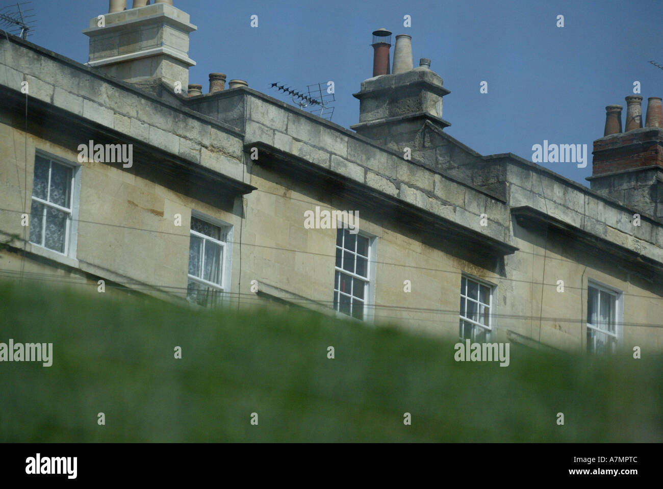 The upper floor of a Georgian Terrace is glimpsed over the brow of a ...