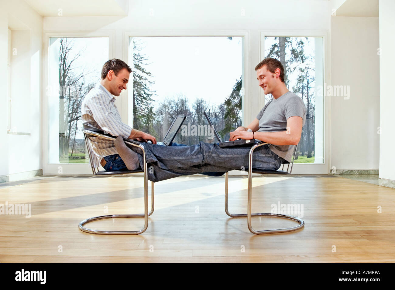 Two men working on the computers Stock Photo - Alamy