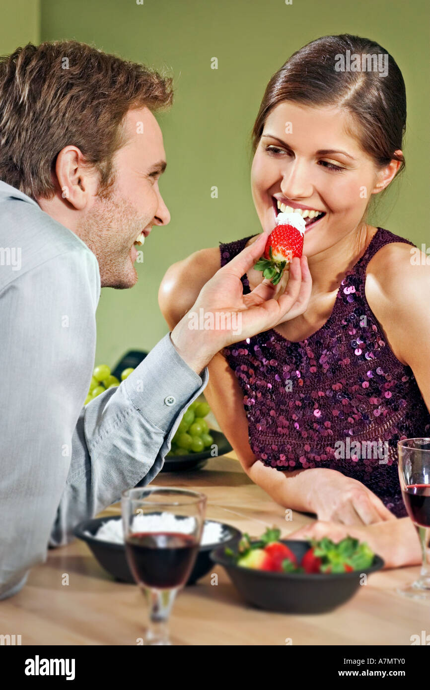 Young couple eating at home Stock Photo - Alamy