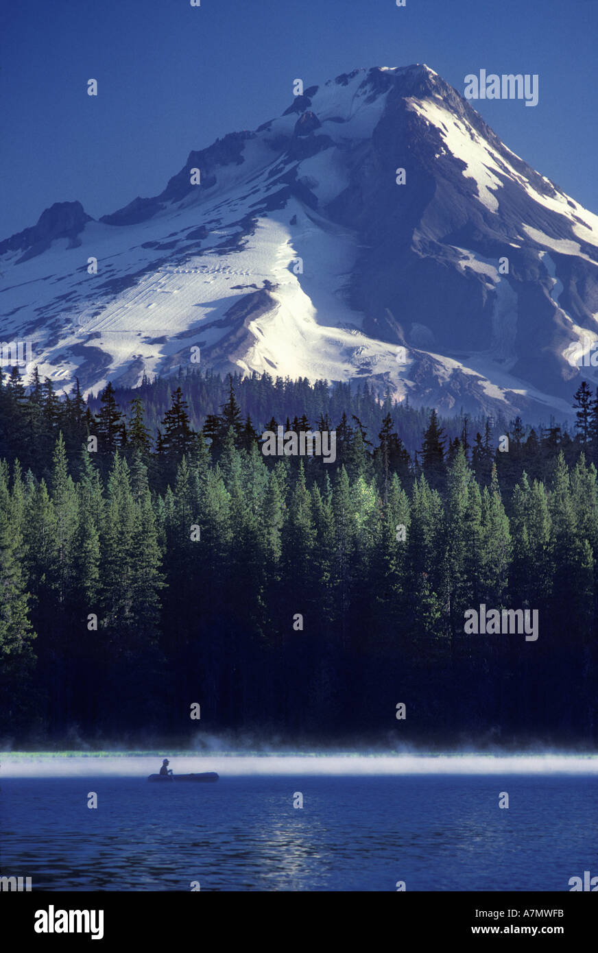 Man paddling raft in the misty morning on Frog Lake with Mt. Hood ...