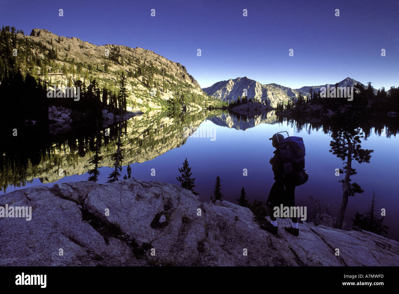 Backpacker overlooking Looking Glass Lake in Eagle Cap Wilderness at ...