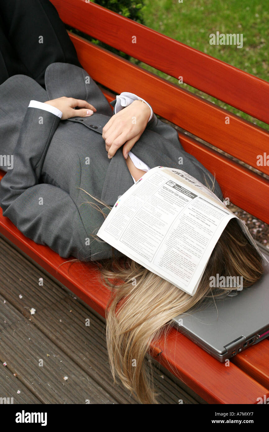 Young woman lying on bench Stock Photo - Alamy