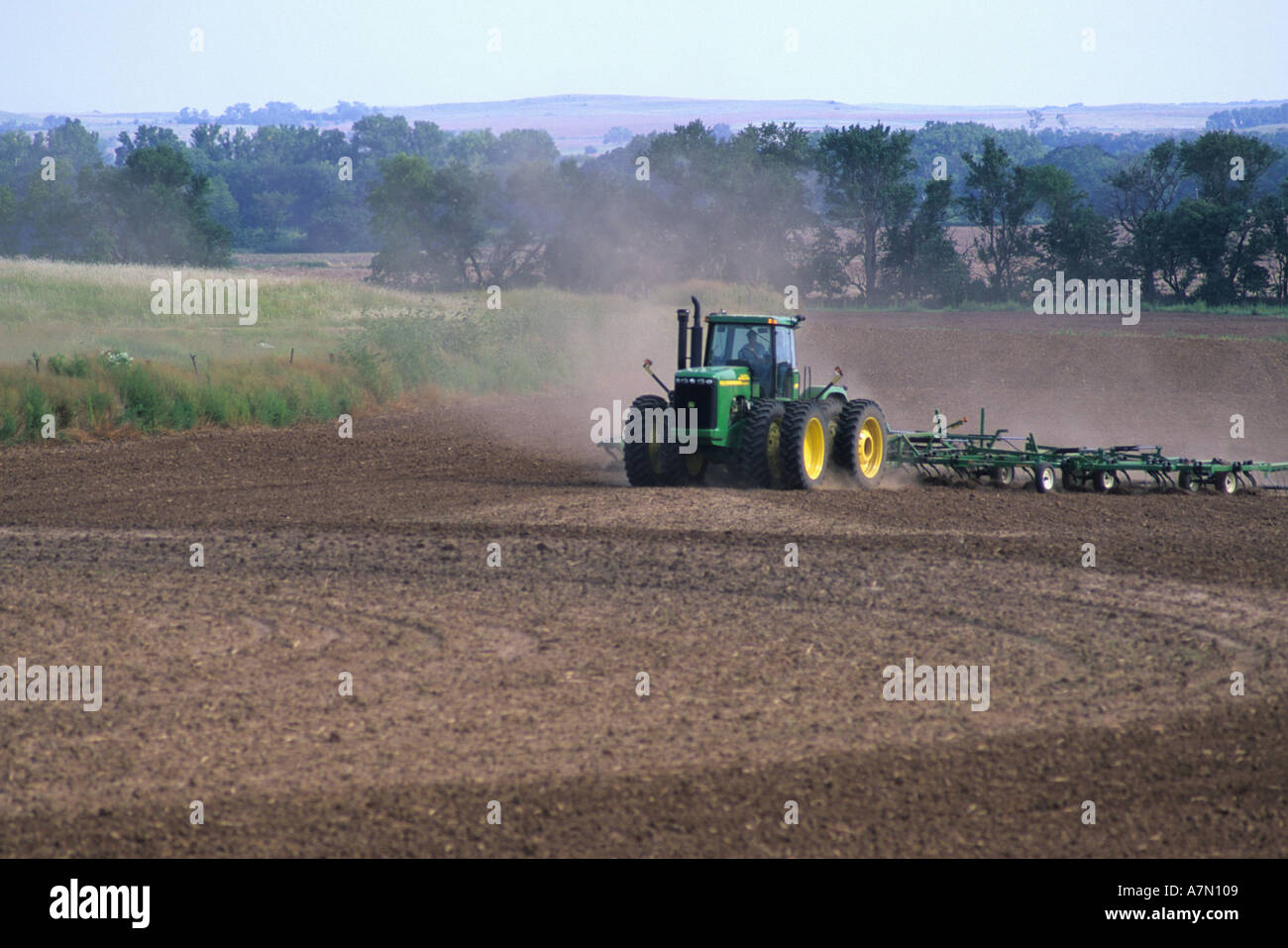 Eight wheel tractor making turns in Lincoln County Kansas east of the ...