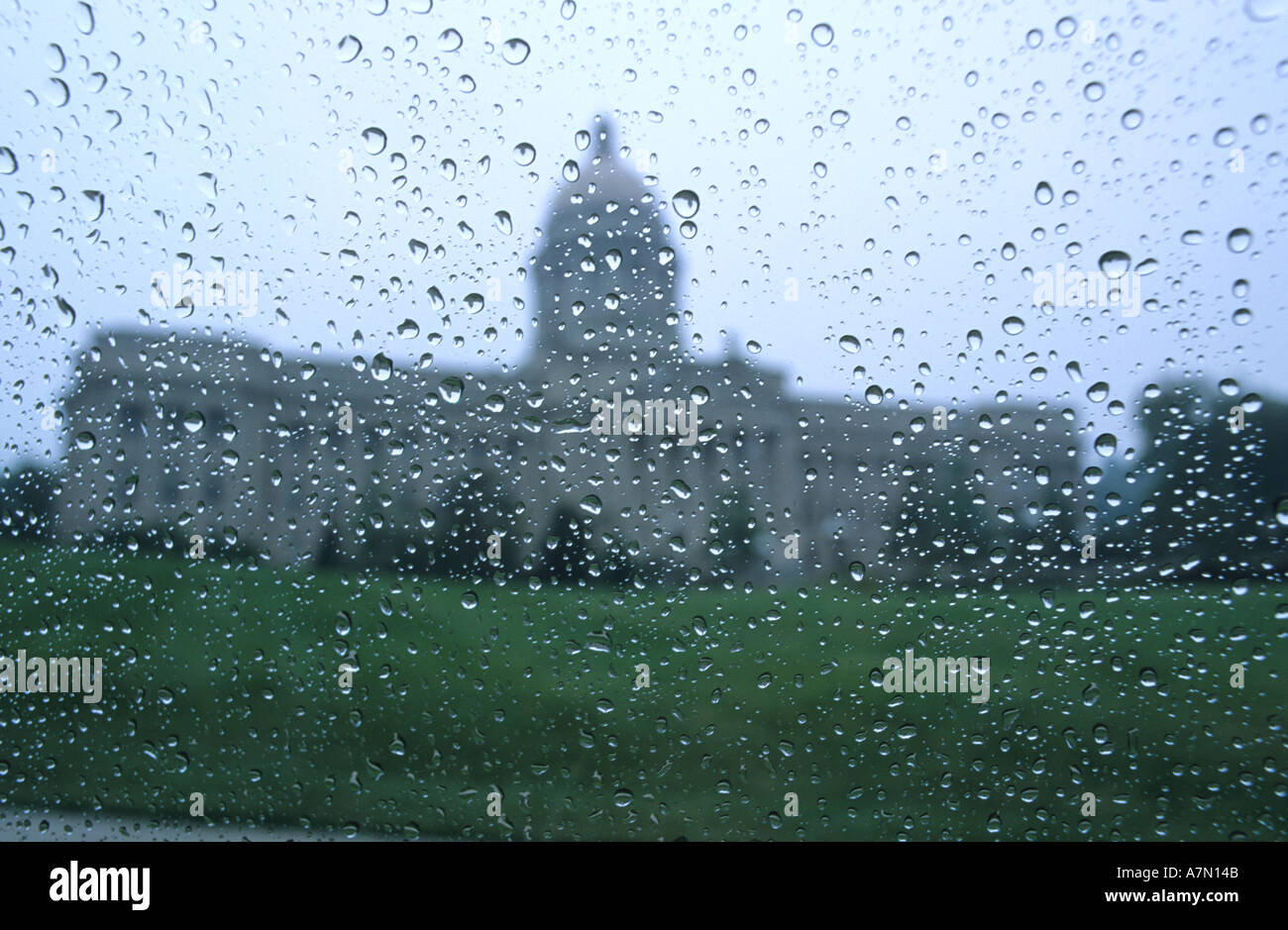 Rain drops on a window with the Kentucky state capitol building in the ...