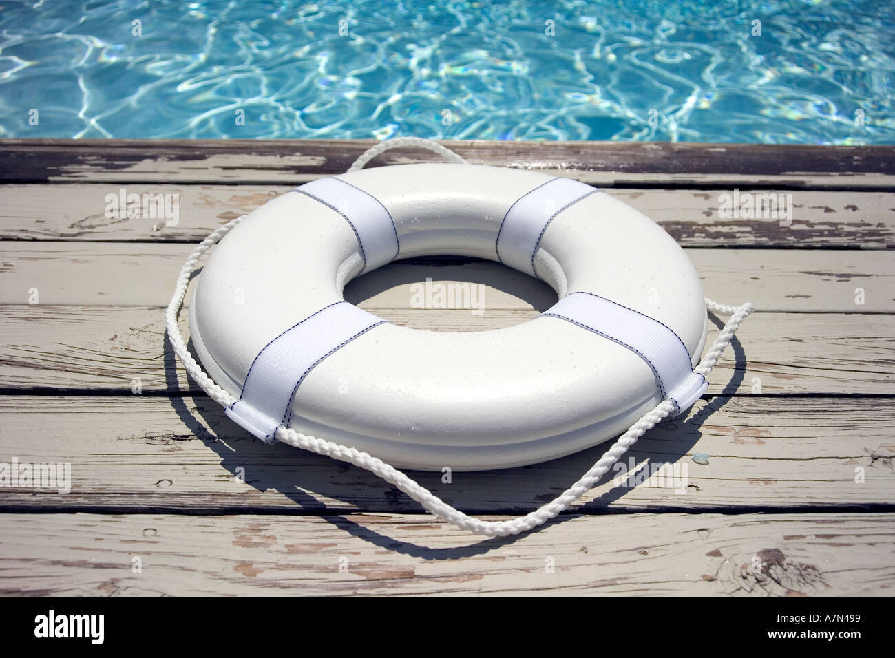 Life preserver on pool deck life jacket Stock Photo - Alamy