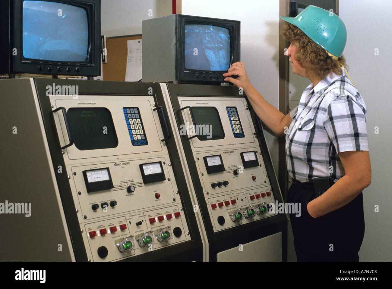 Woman employee working at a french fry factory with computer controlled ...