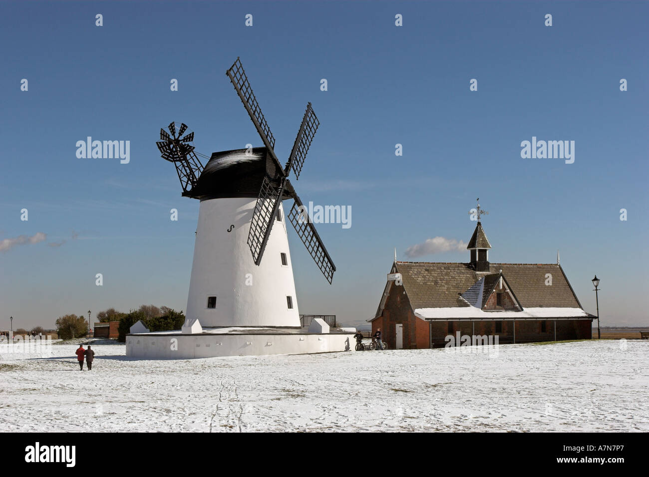 Windmill and lifeboat museum in the snow on the seafront at Lytham ...