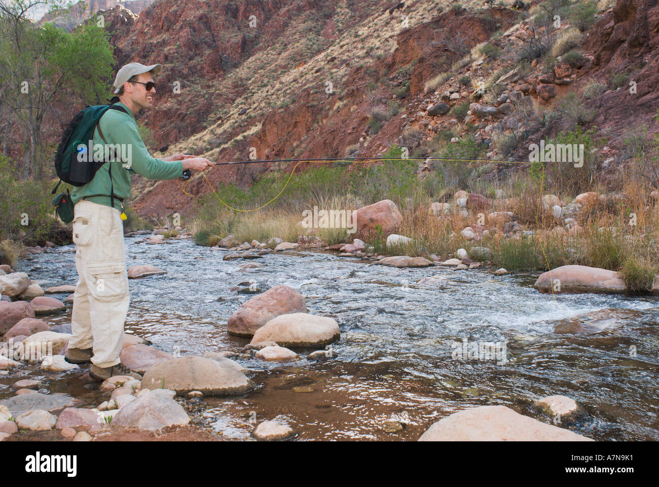 A man is fly fishing at Bright Angel Creek at Phantom Ranch at the ...