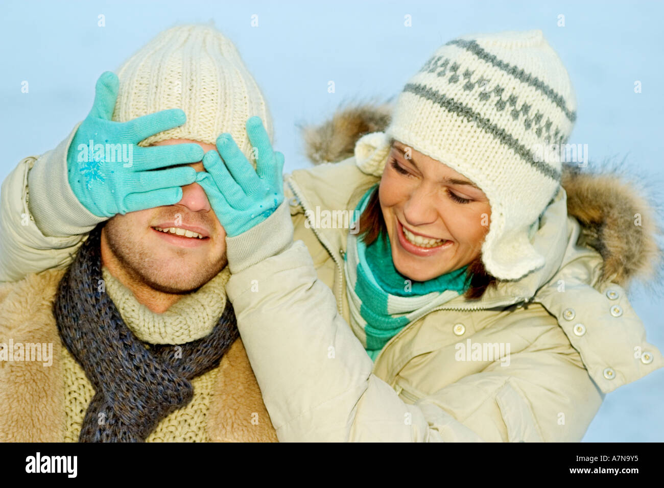 outdoor day winter woman man young 25 30 couple hug play fun recreation ...