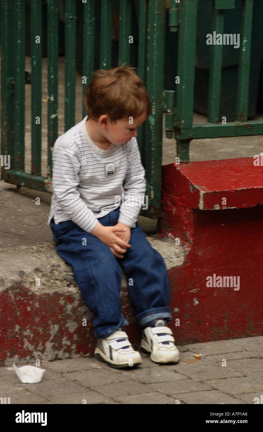 Child sitting on curb hi-res stock photography and images - Alamy