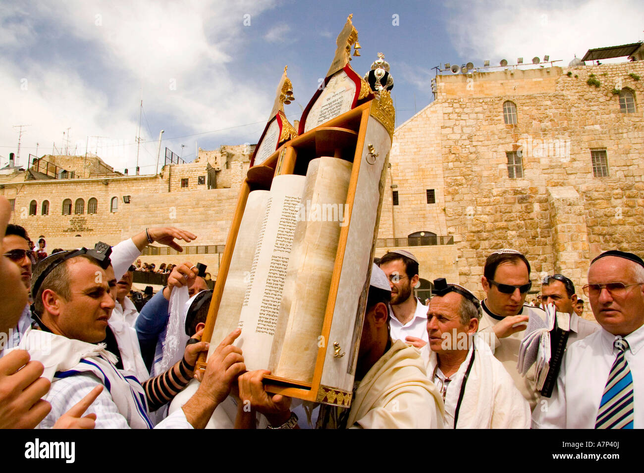 jJws celebrating their sons' bar mitzvah with reading from the Torah ...