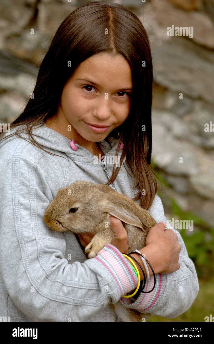 child holds rabbit in arms, France Stock Photo - Alamy