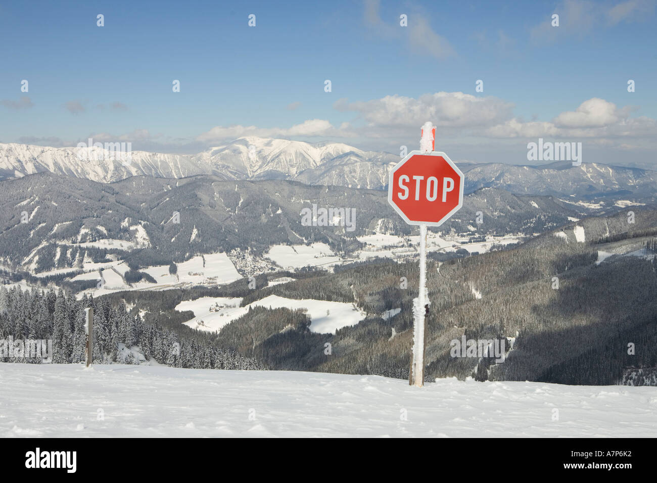Stop sign and in the background the mountain Schneeberg ski area ...