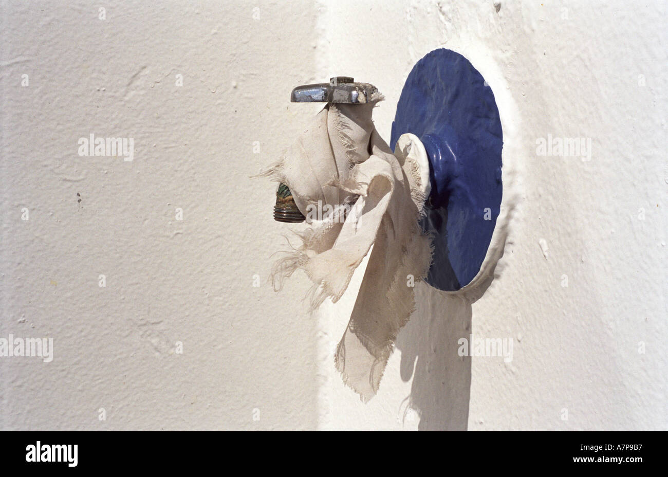 Water tap wrapped with cotton rag Stock Photo - Alamy
