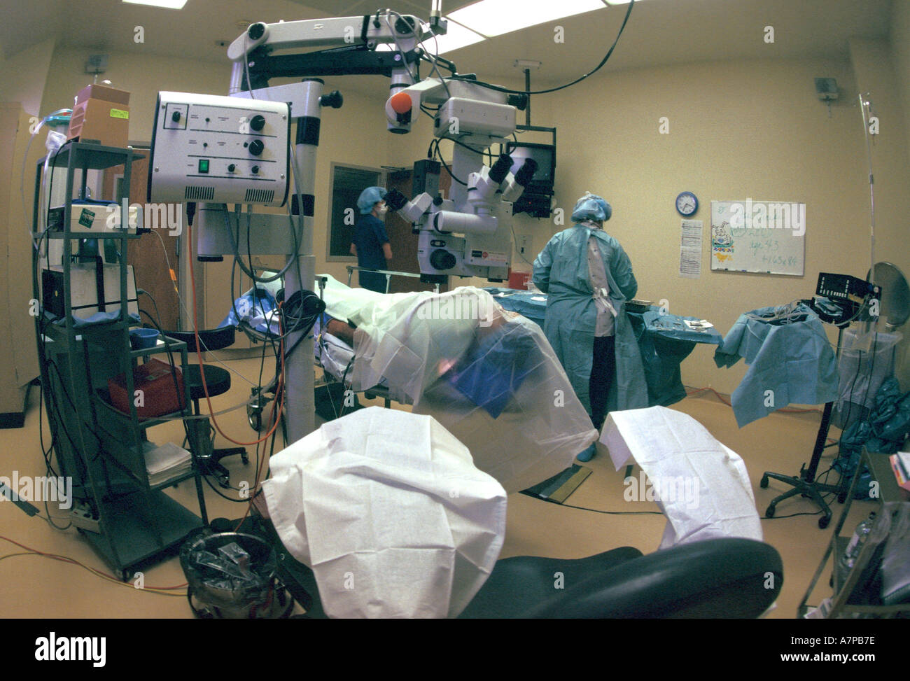 Nurses prepare operating room and electronic overhead operating ...