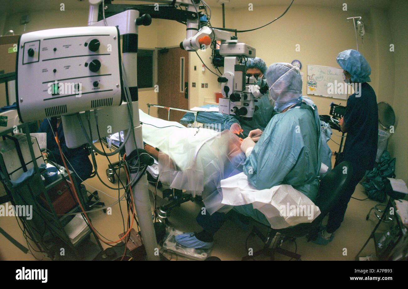 ophthalmologist uses electronic overhead operating microscope to ...