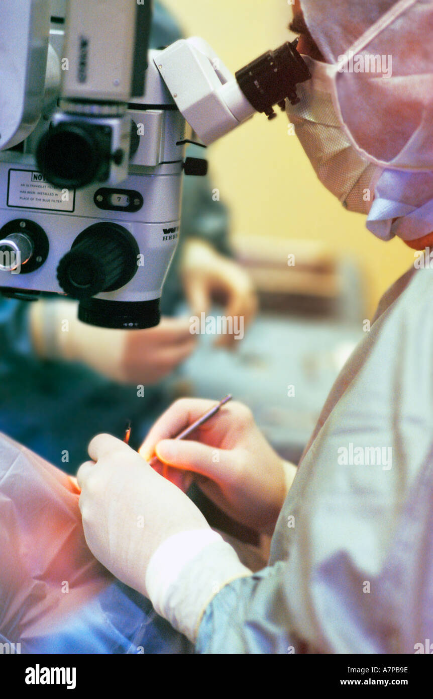 Ophthalmologist uses electronic overhead operating microscope to ...