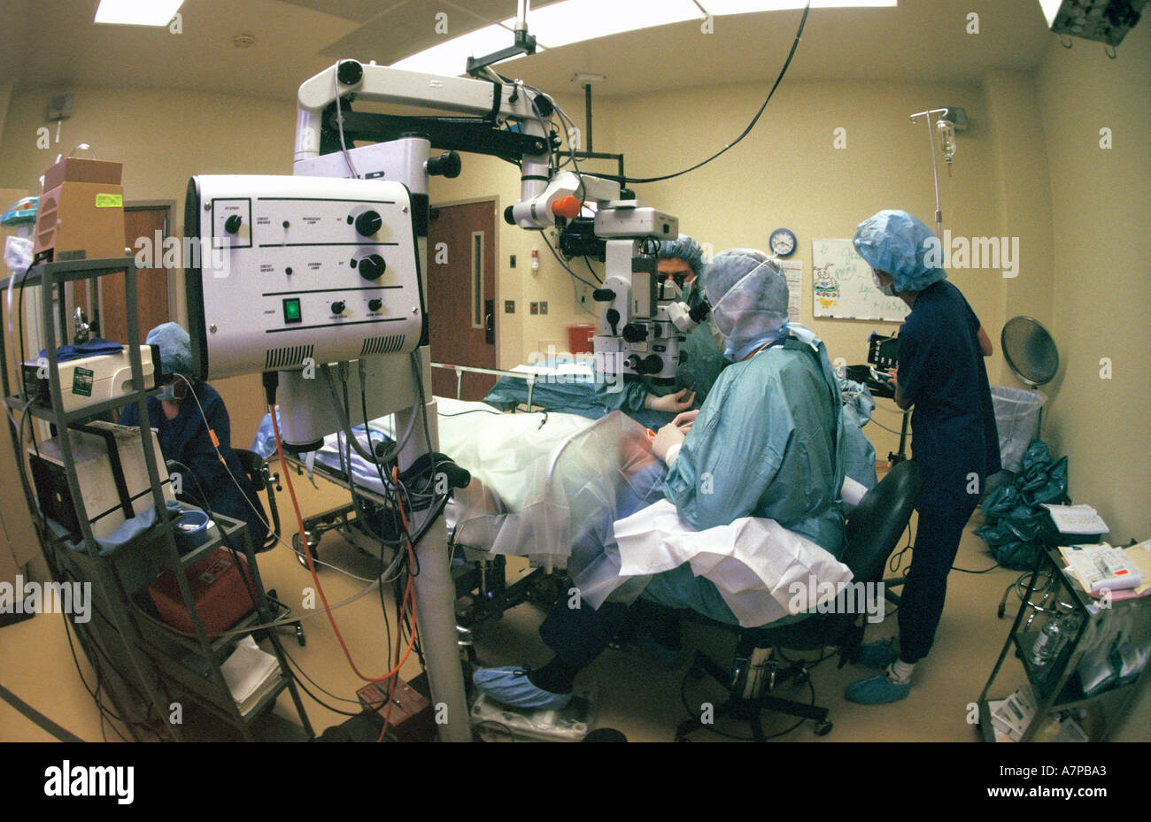Ophthalmologist uses electronic overhead operating microscope to ...