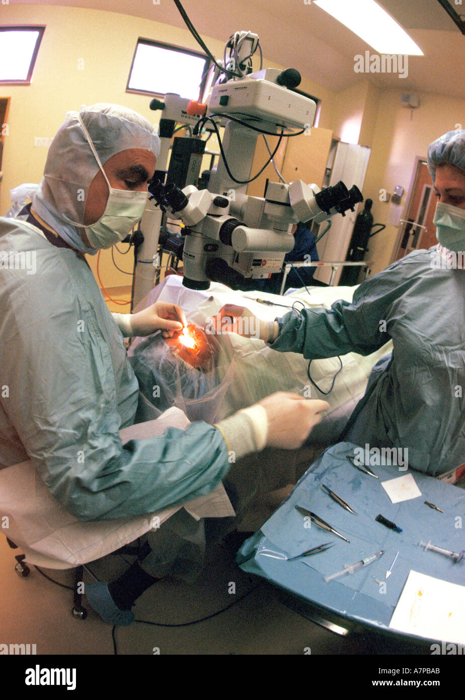 Ophthalmologist uses electronic overhead operating microscope to ...
