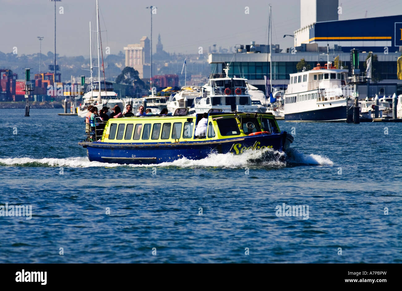 A passenger ferry cruises the Yarra river in the Melbourne Docklands ...