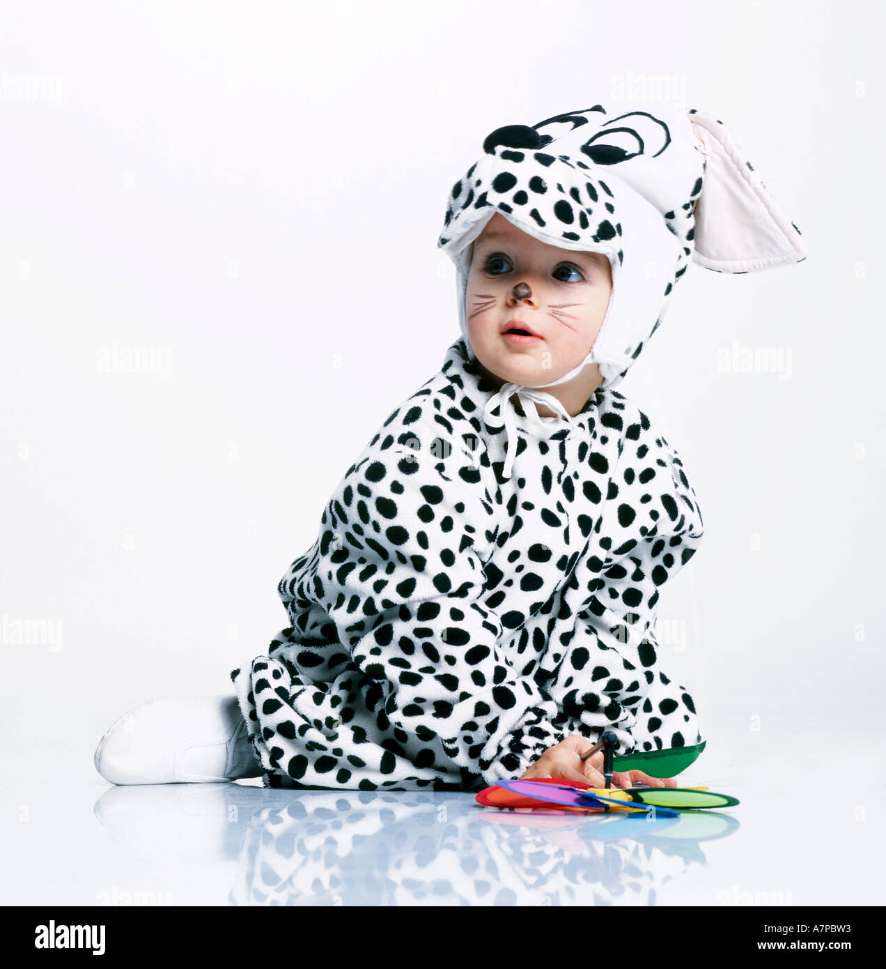 indoor studio child kid 5 10 smile smiling crouch sit floor fun play ...