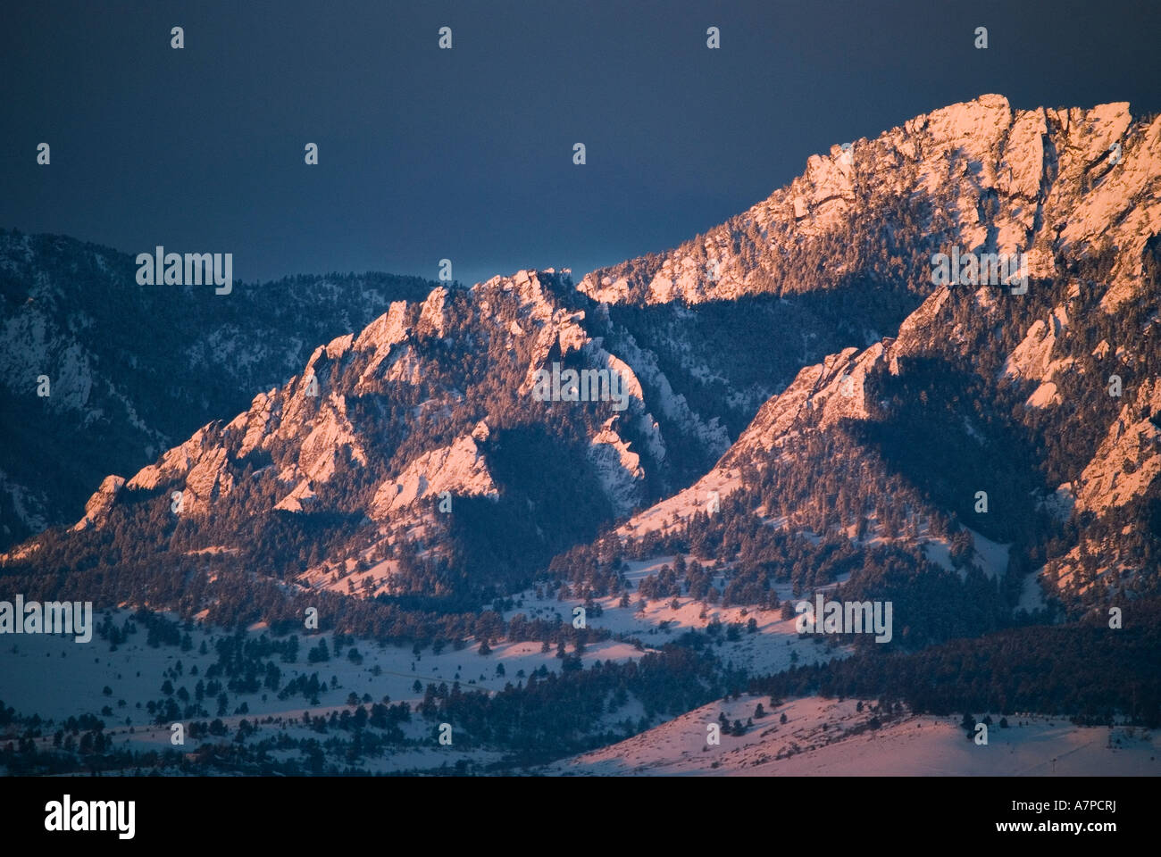 Alpenglow from winter sunrise on Flatirons Fountain Formation sandstone ...