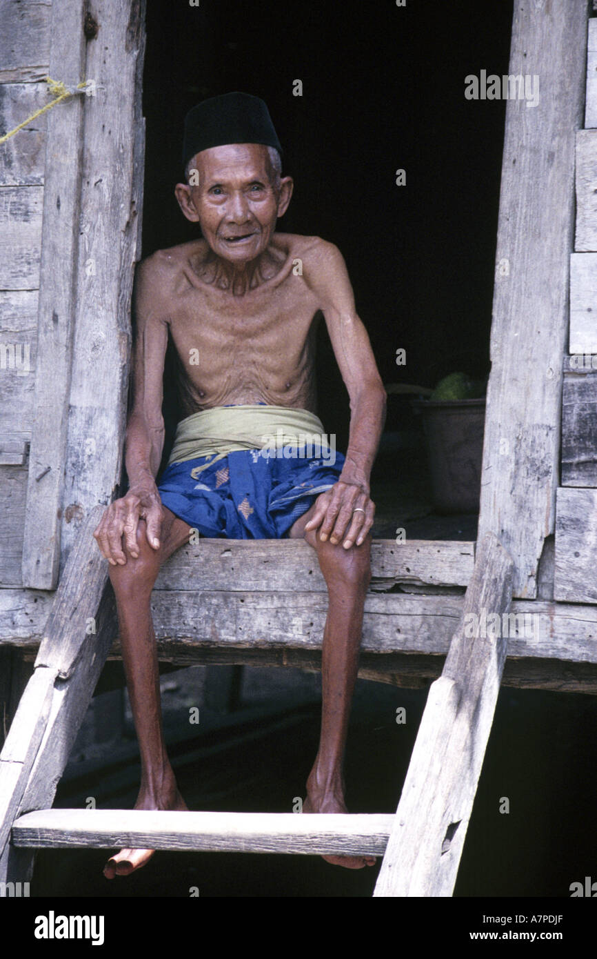 man at the entrance of his house, Sunda Islands, Indonesia Stock Photo ...