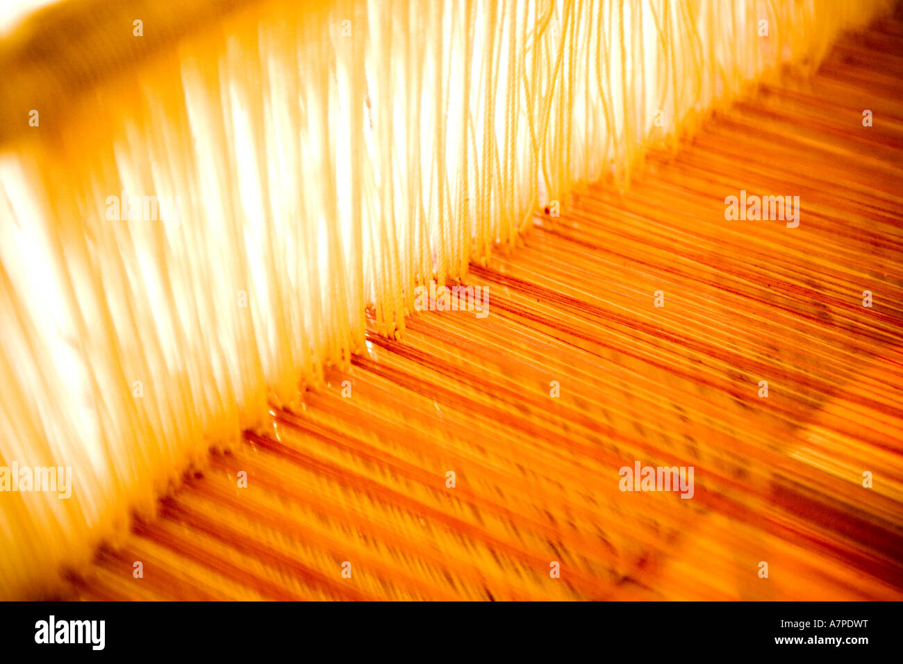 Bright threads on a traditional loom in northern Thailand Stock Photo ...