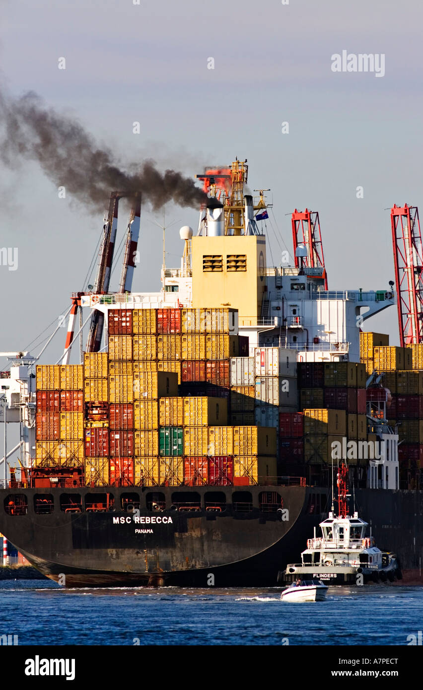 Shipping Industry / A Container Ship docking with a Tugboat in ...