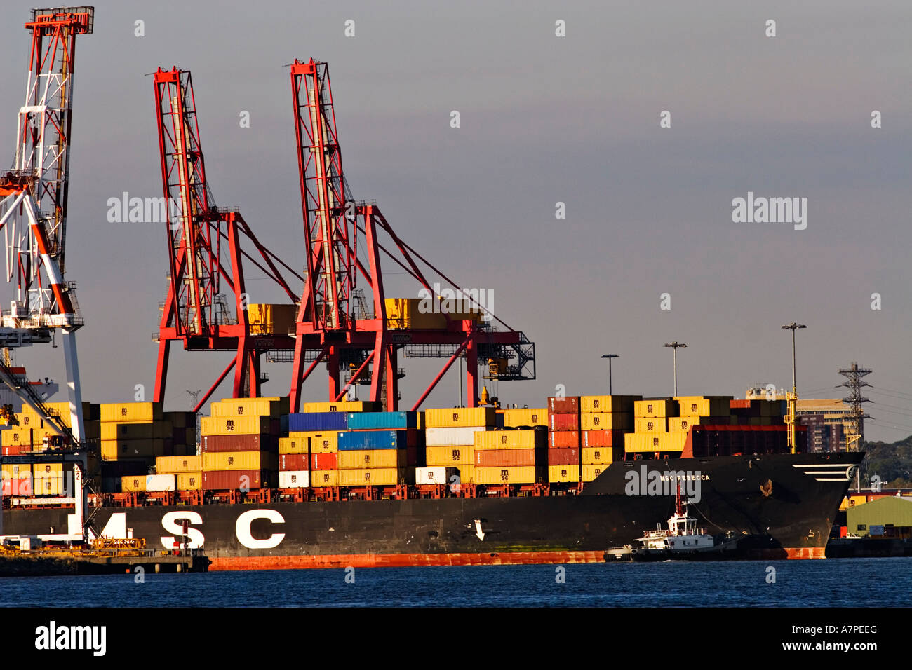 Shipping Industry / A Container Ship docking with a Tugboat in ...