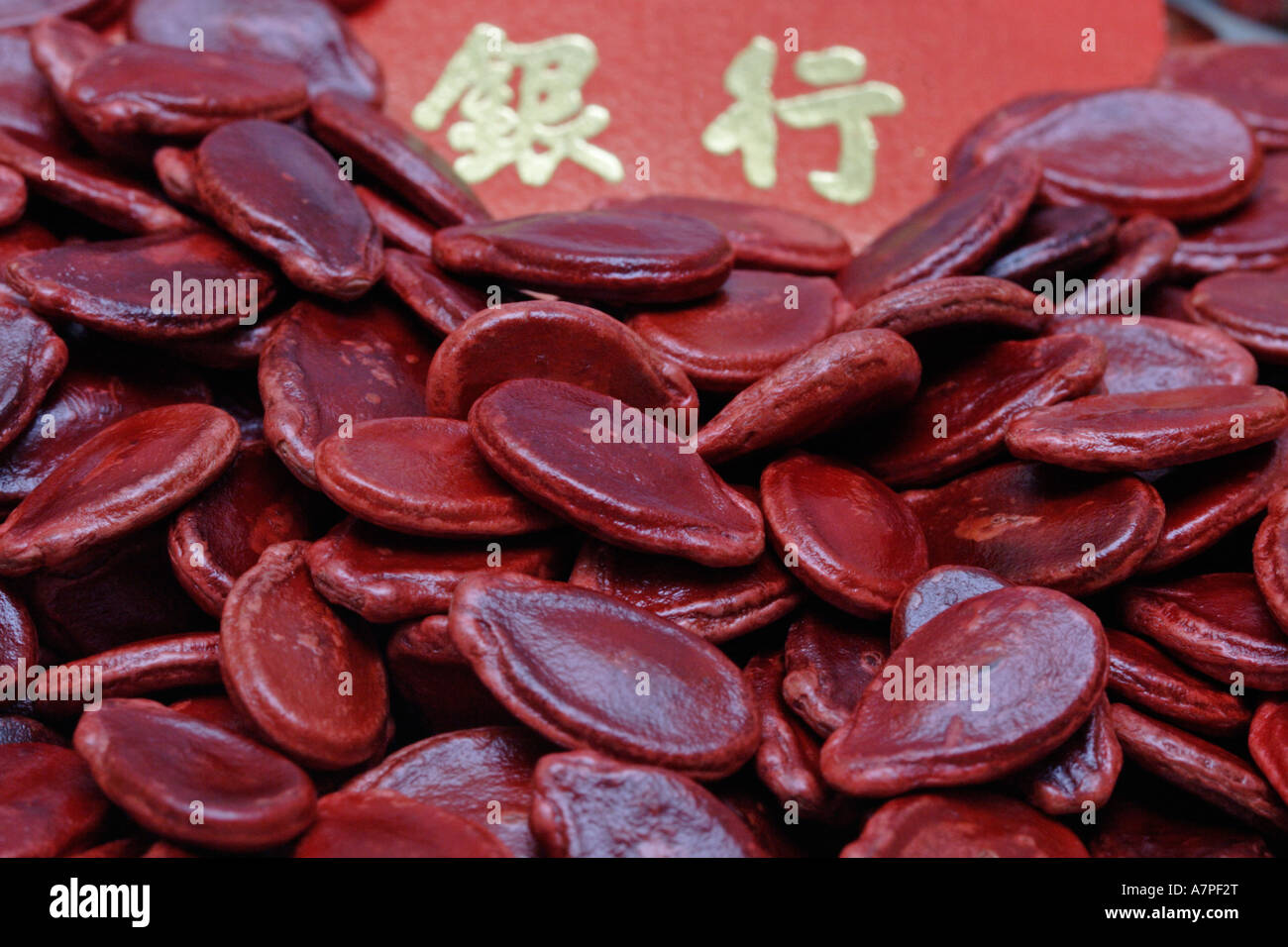 Red Seeds with Chinese Characters in background Stock Photo - Alamy