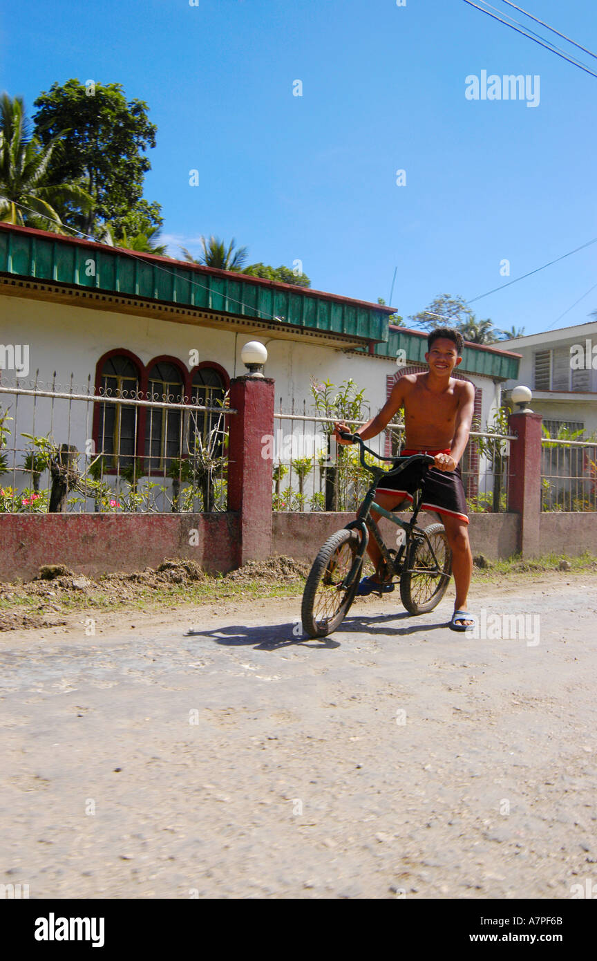 Boy on his bike outside of some shops in Philippines Stock Photo - Alamy