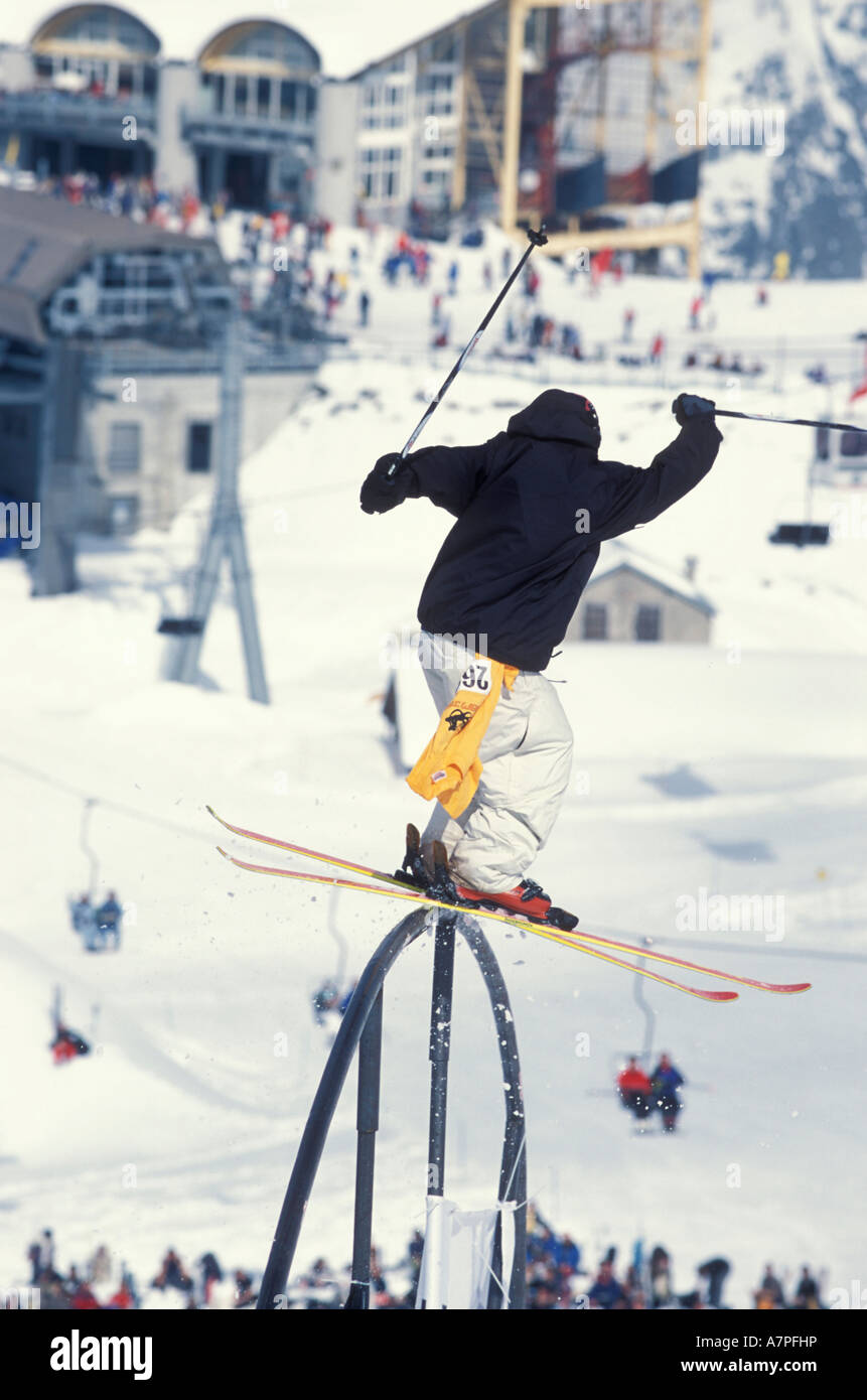Extreme skier in a competion performing a stunt on a rail in Chamonix ...