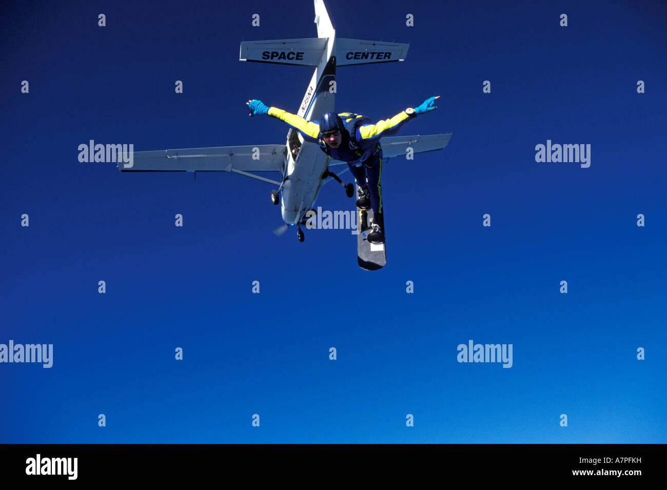 Sky surfer having just jumped out of the plane and heading downwards ...