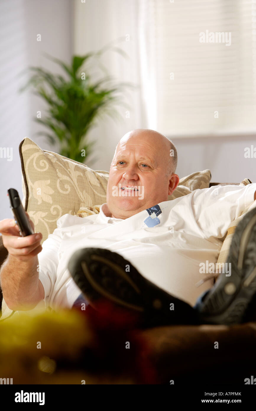 Happy single man watching TV at home Stock Photo - Alamy