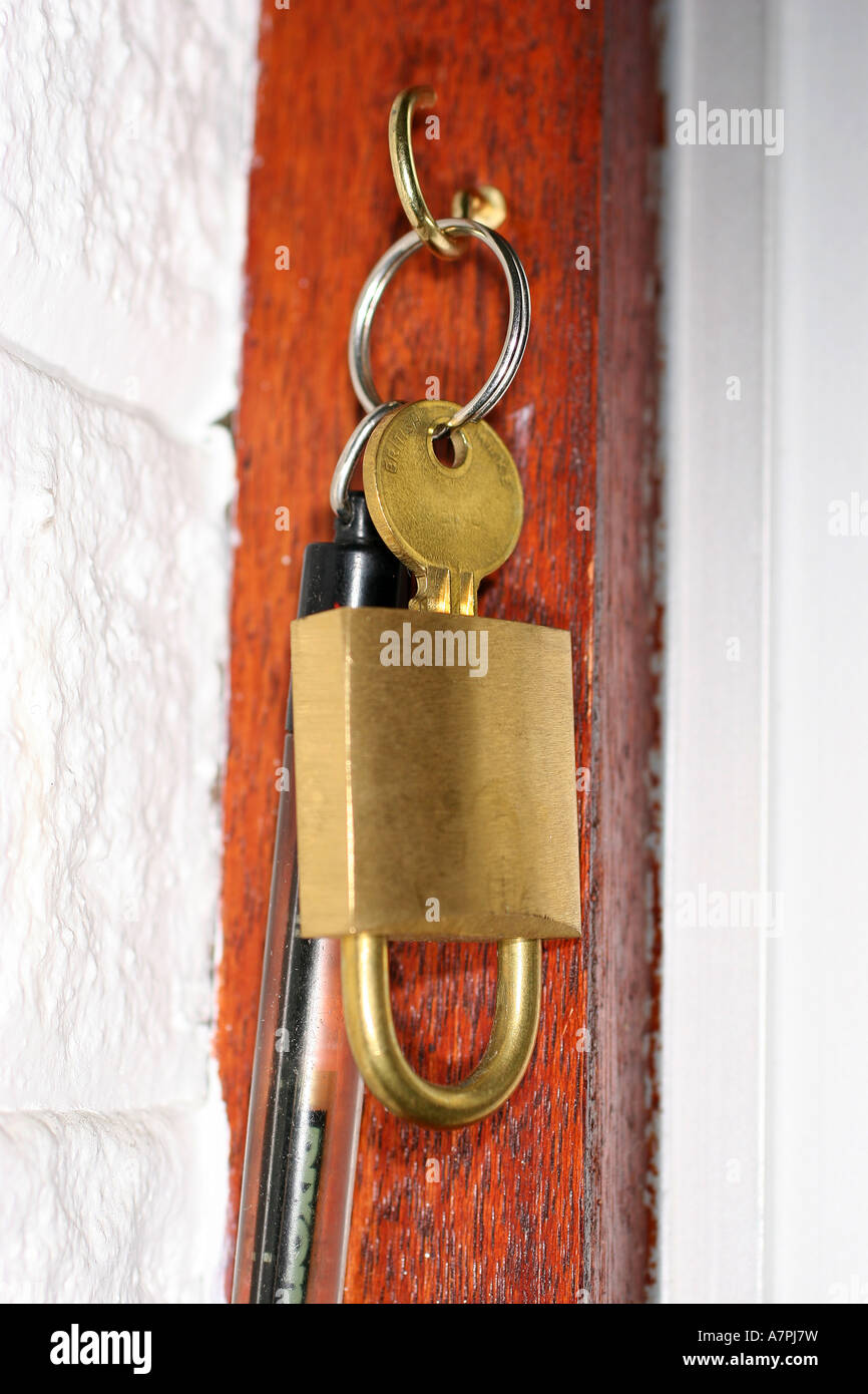 Modern brass high security padlock and key Stock Photo - Alamy