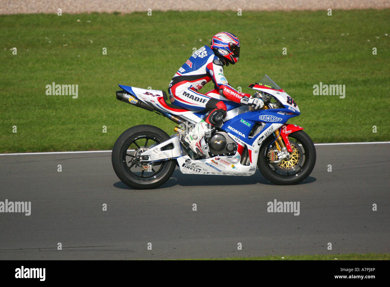 Racing motorcycle and rider in competition at high speed at Donnington ...