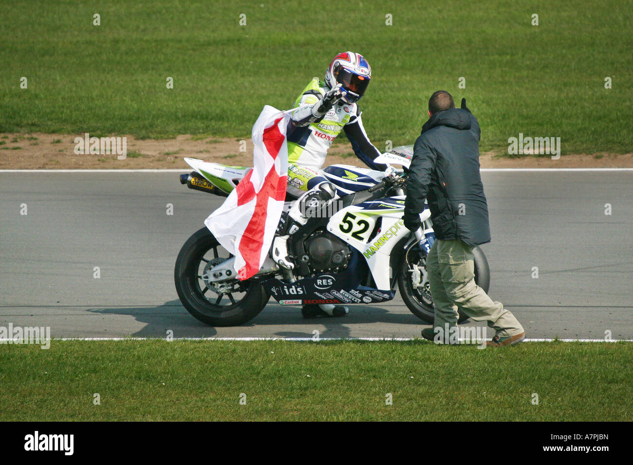 Racing motorcycle and rider in competition with Saint George England ...