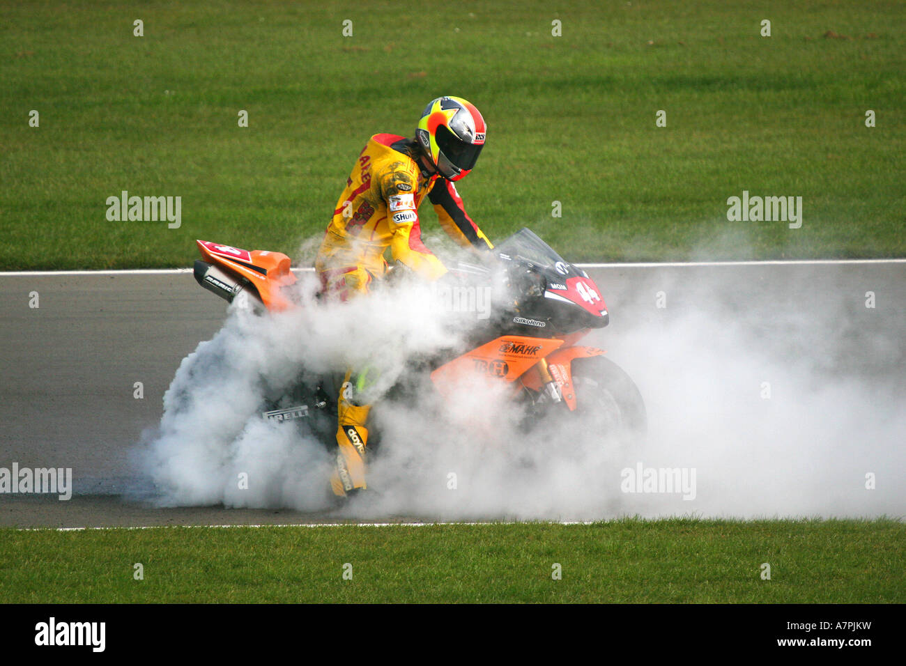 Rider smoking his bike rear tyre after a championship race Stock Photo ...