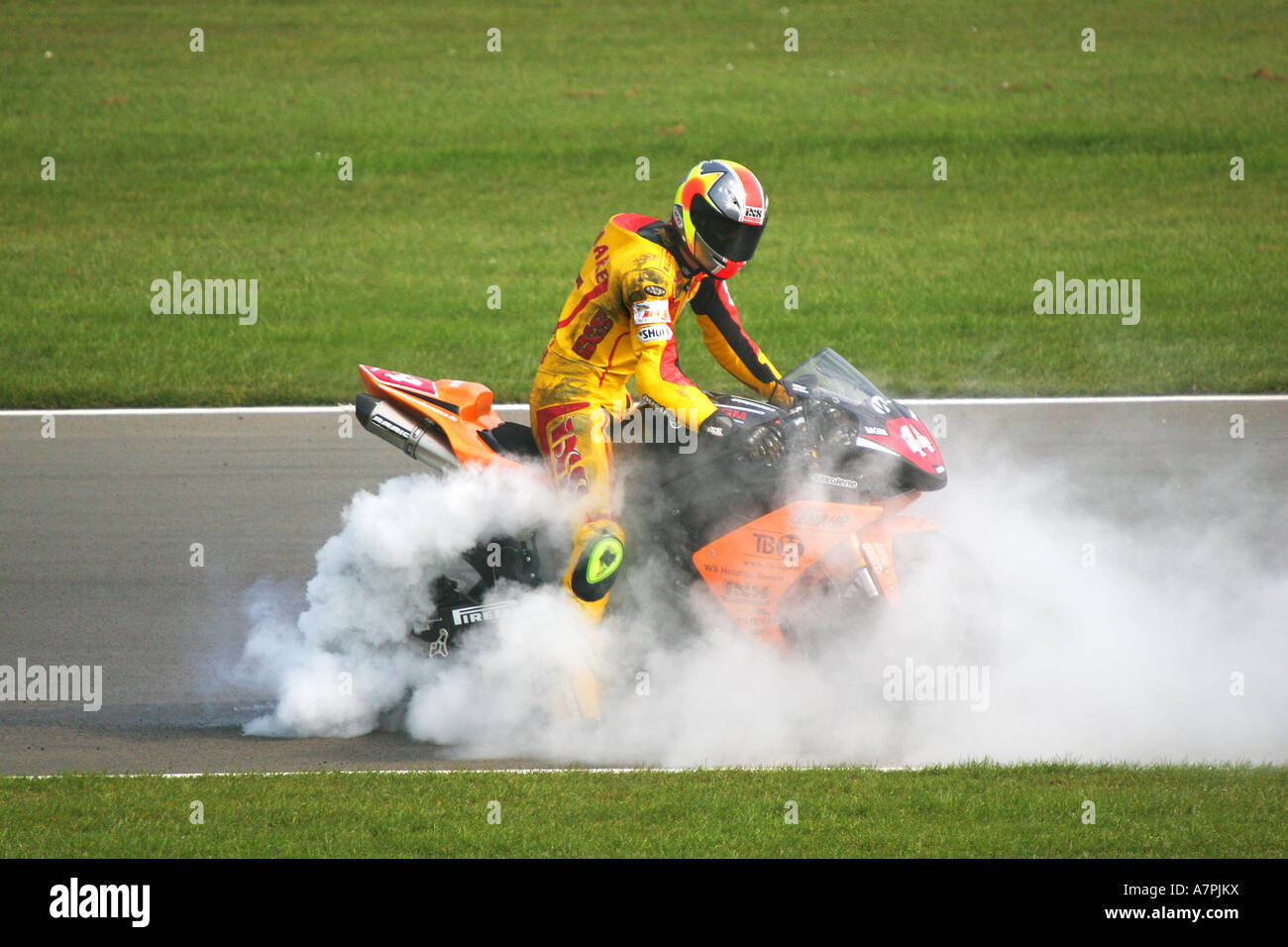 Rider smoking his bike rear tyre after a championship race Stock Photo ...