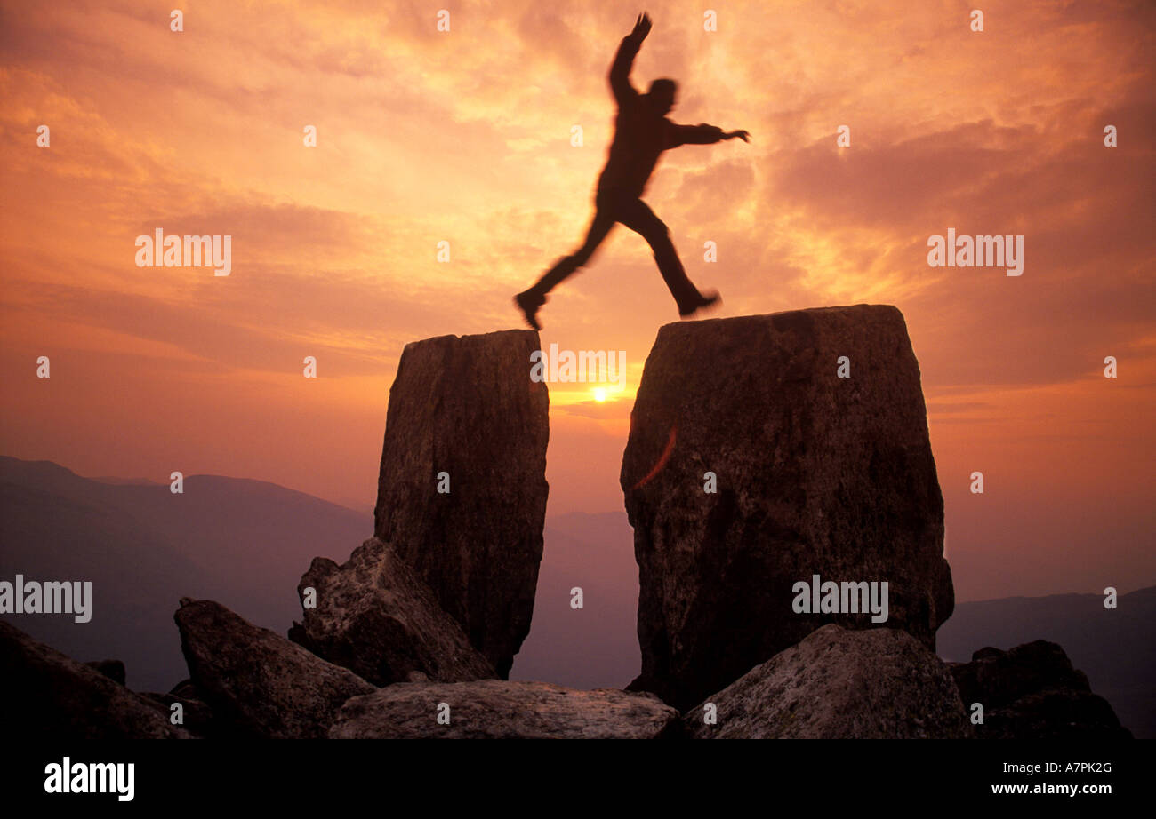 Man jumping over rocks, Snowdonia Stock Photo - Alamy