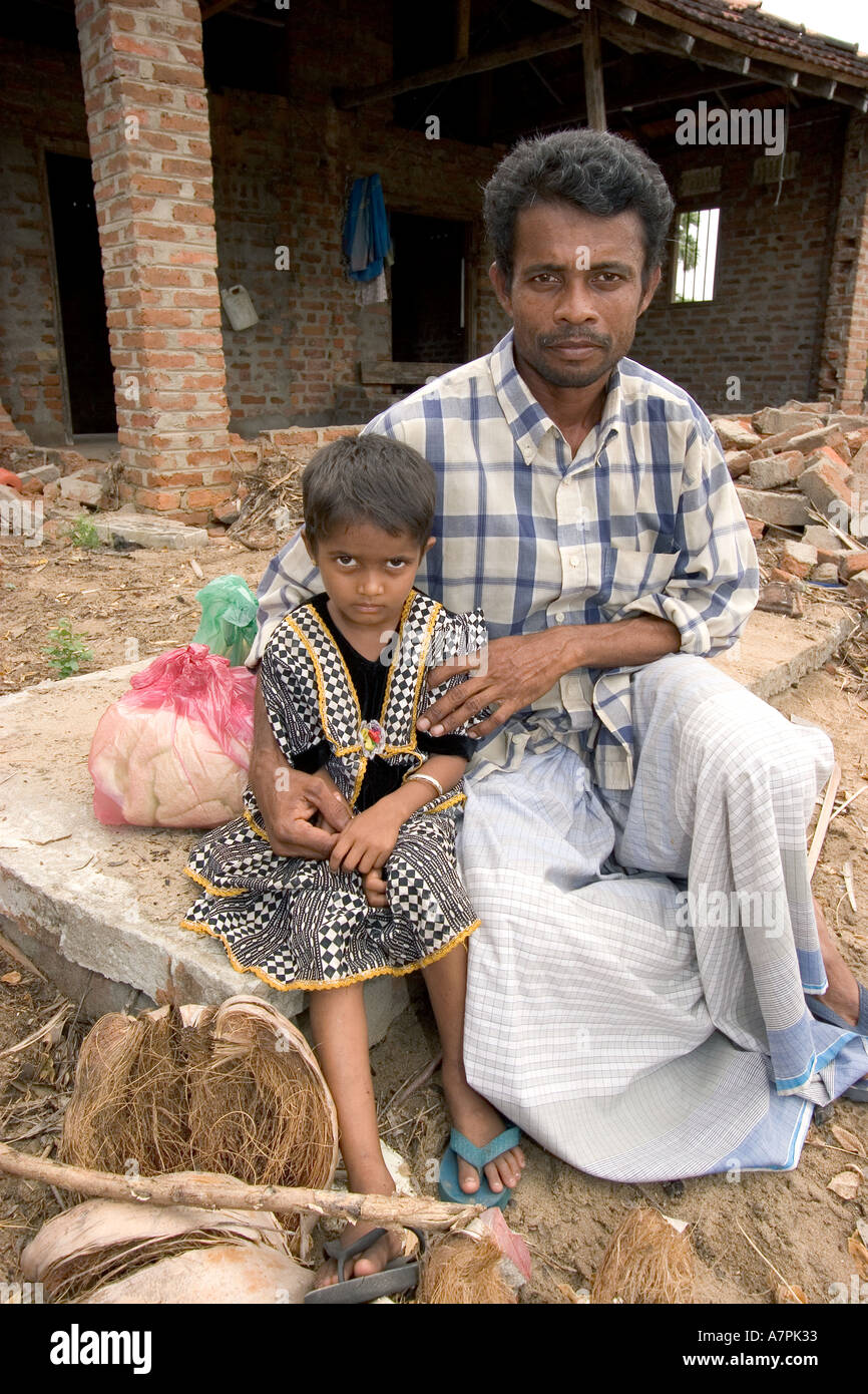 Grieving Fisherman Nazeer with daughter Parrisa outside tsunami wrecked ...