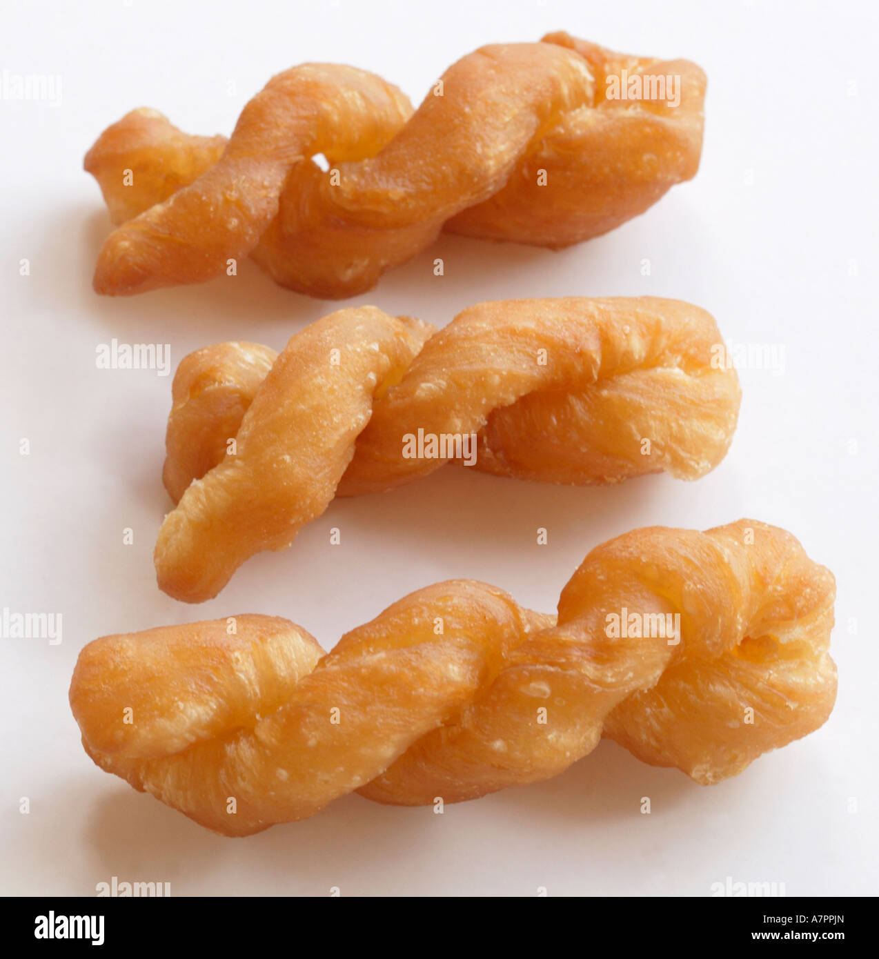 Koeksuster or koeksister twists or braids of dough deep fried and ...
