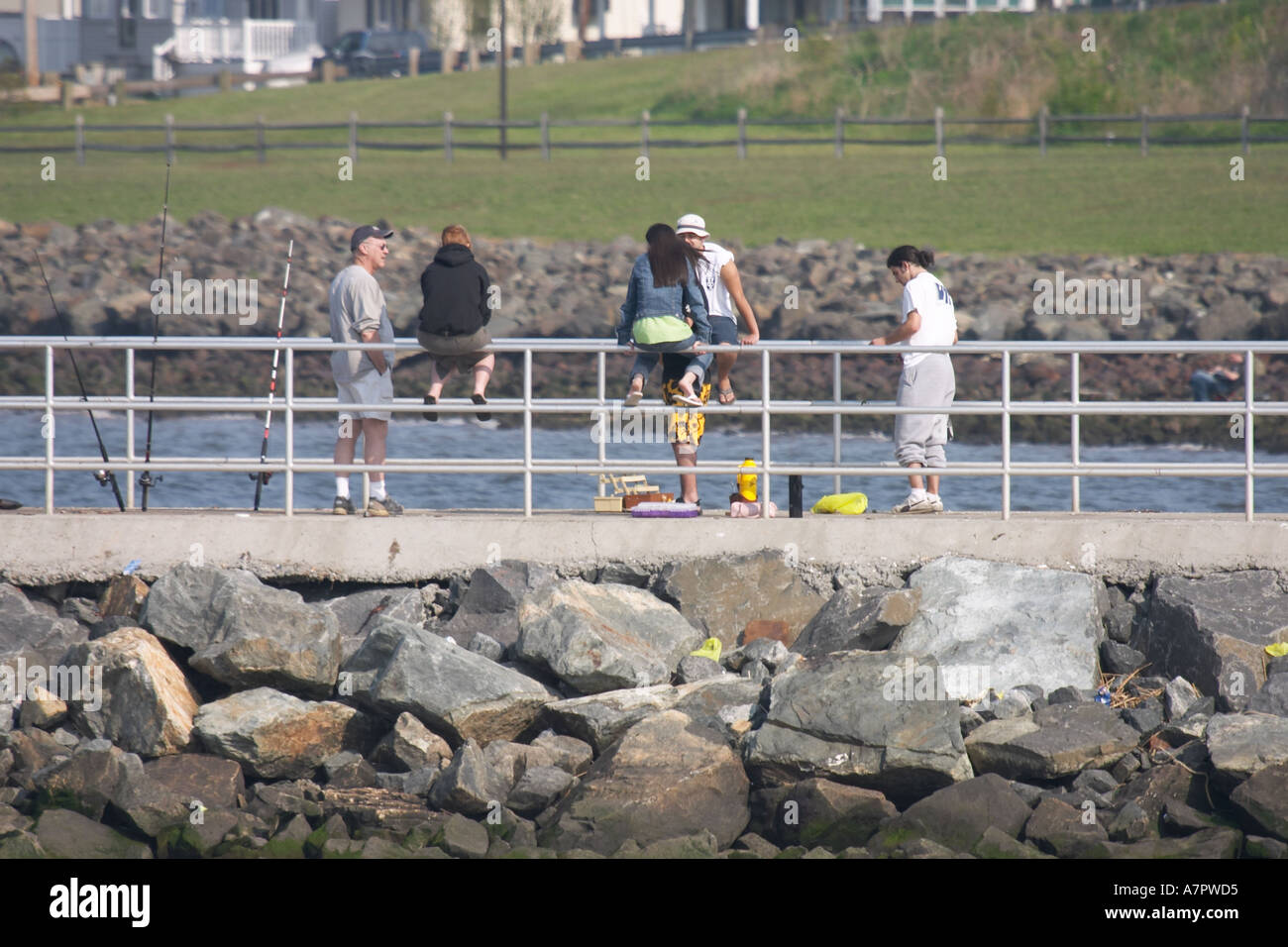 Fishing from a rock jetty Stock Photo - Alamy